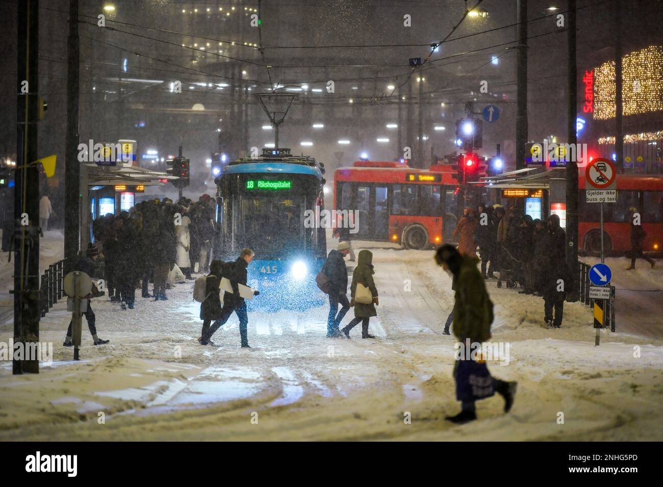 Trams and buses in snowy conditions at Jernbanetorget in central Oslo ...