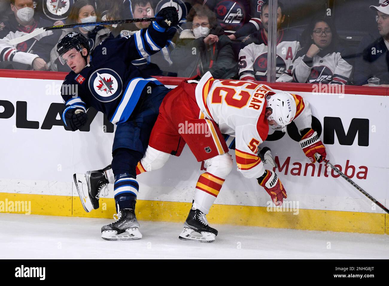 Calgary Flames' Mackenzie Weeger (52) collides with Winnipeg Jets ...