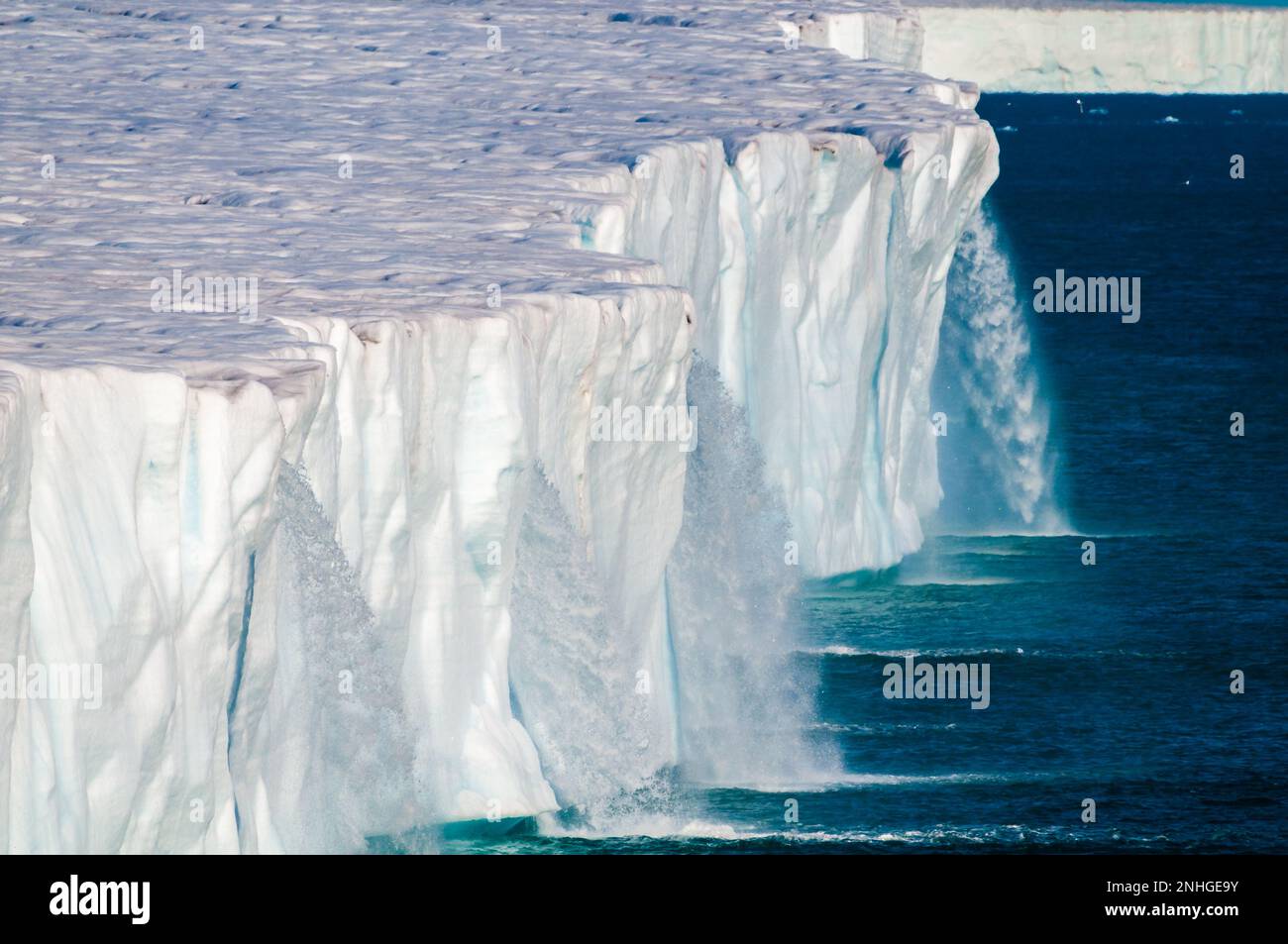 Water pouring off the arctic ice shelf of the Svalbard Islands of ...