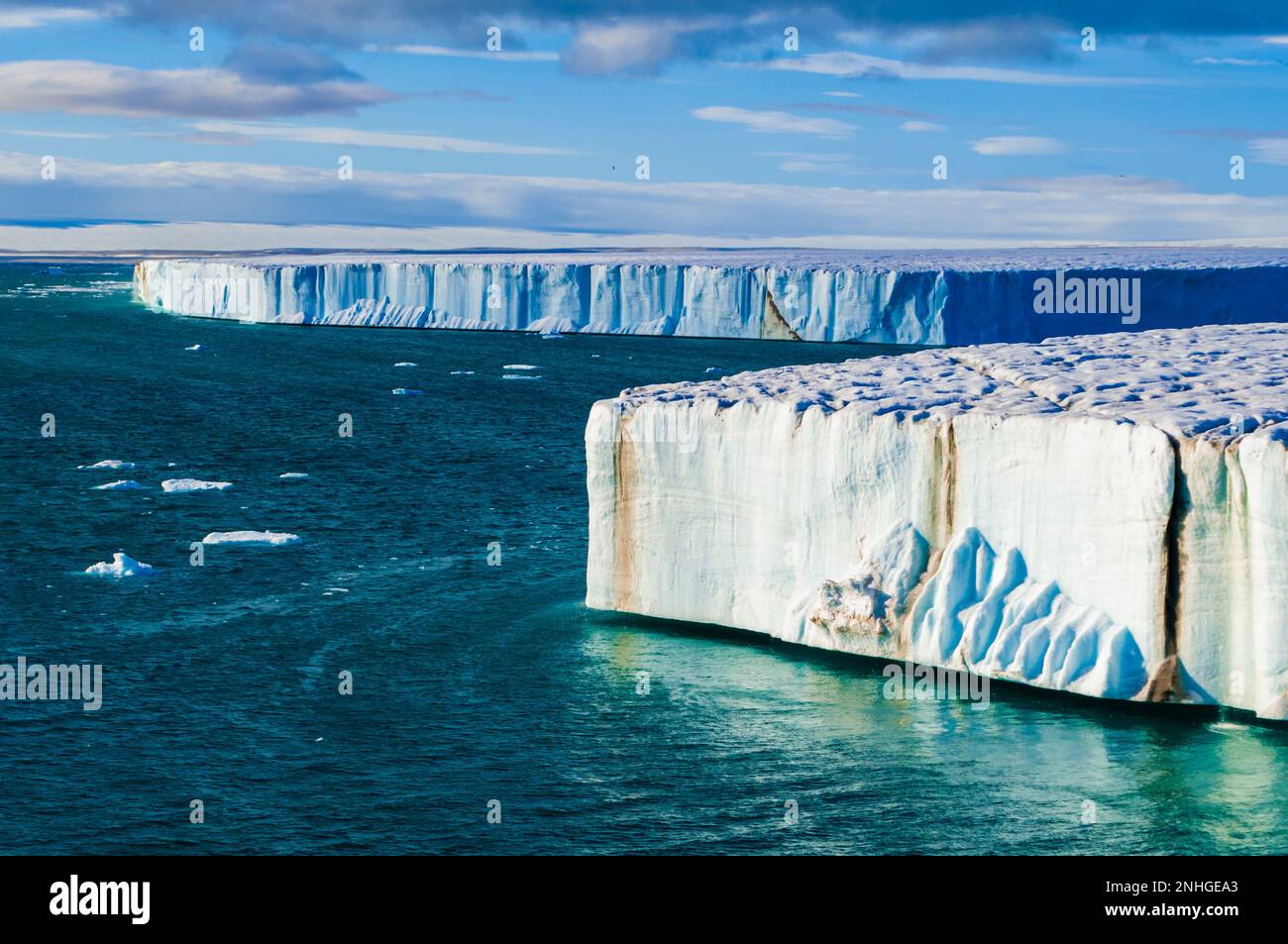 Water pouring off the arctic ice shelf of the Svalbard Islands of ...