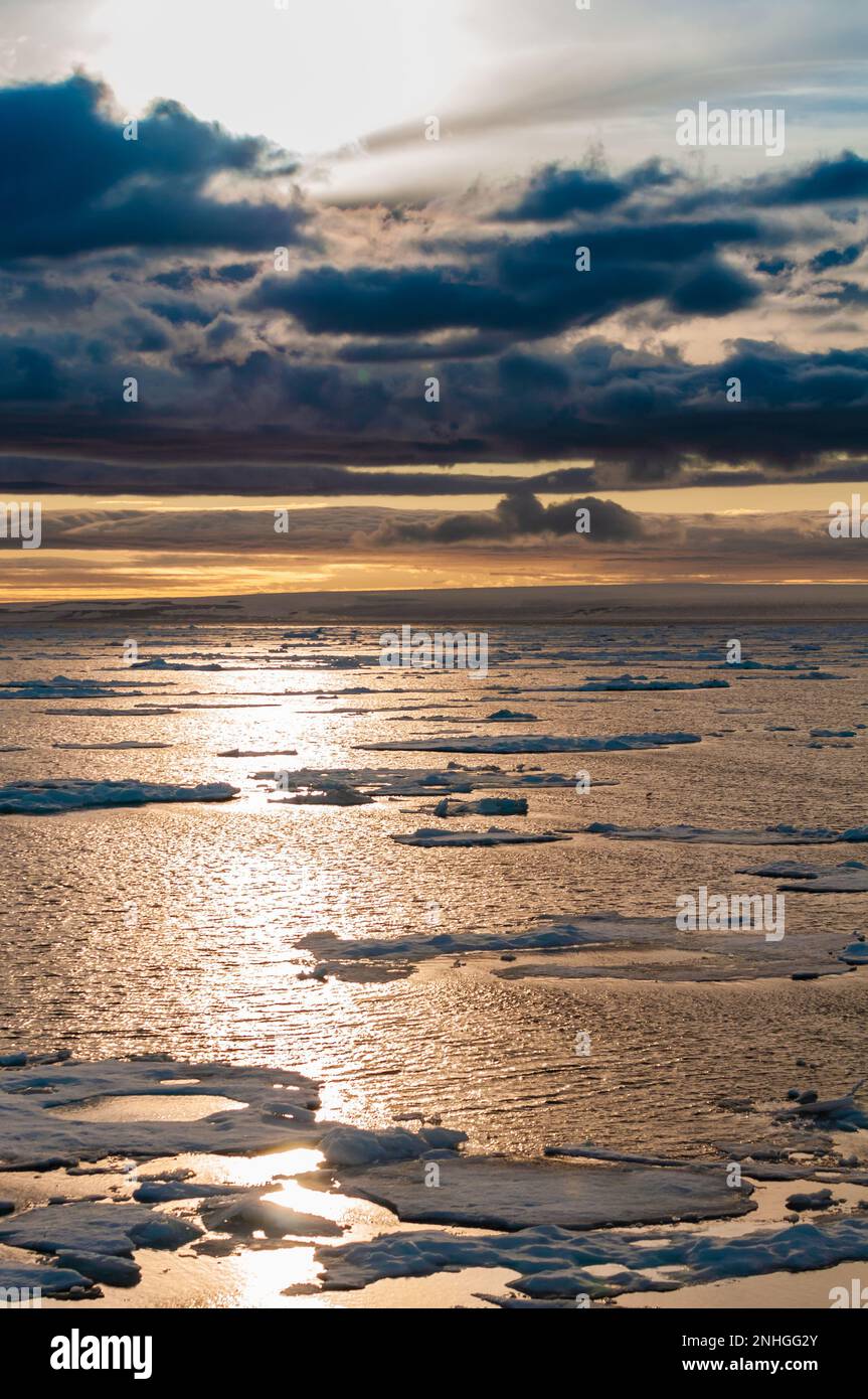 Sunset over broken ice packs in the Arctic ocean around the Svalbard ...