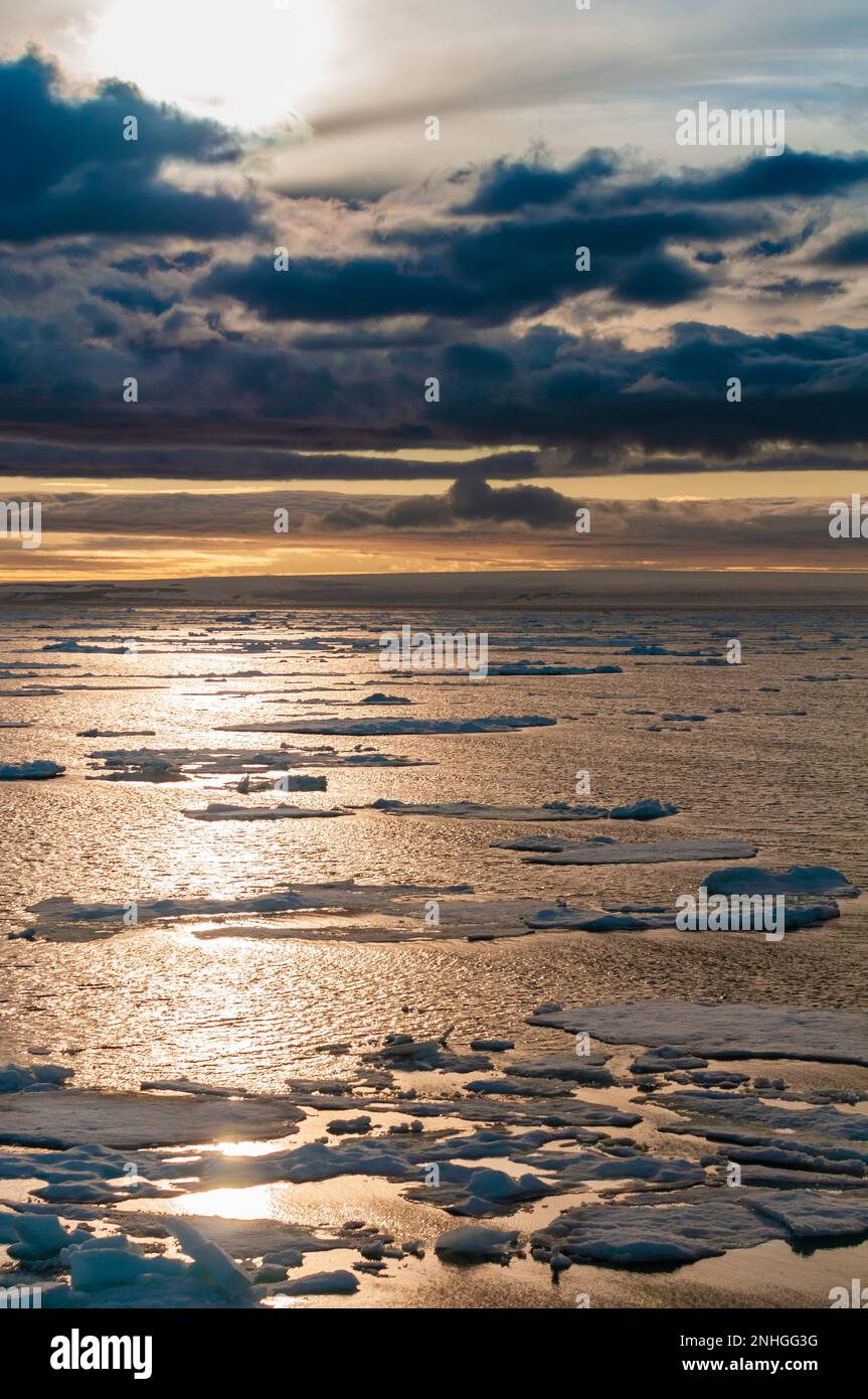Sunset over broken ice packs in the Arctic ocean around the Svalbard ...