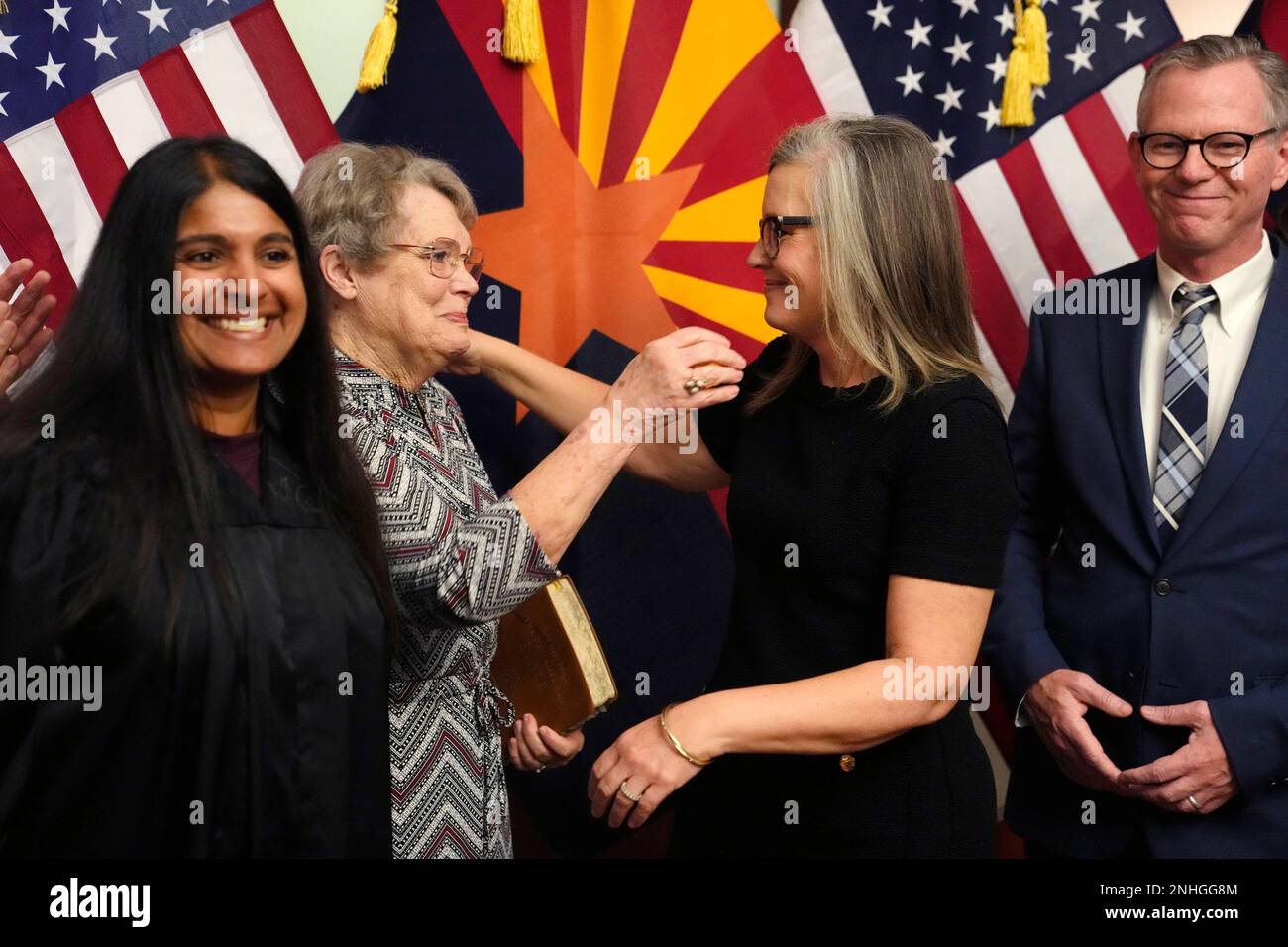 The new Arizona Democratic Gov. Katie Hobbs, second from right, hugs ...