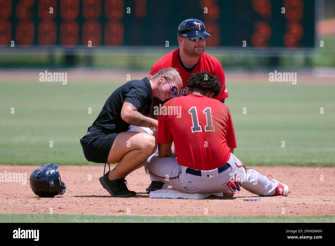 FCL Twins trainer Asja Morello checks on Ricardo Olivar (11) as manager ...