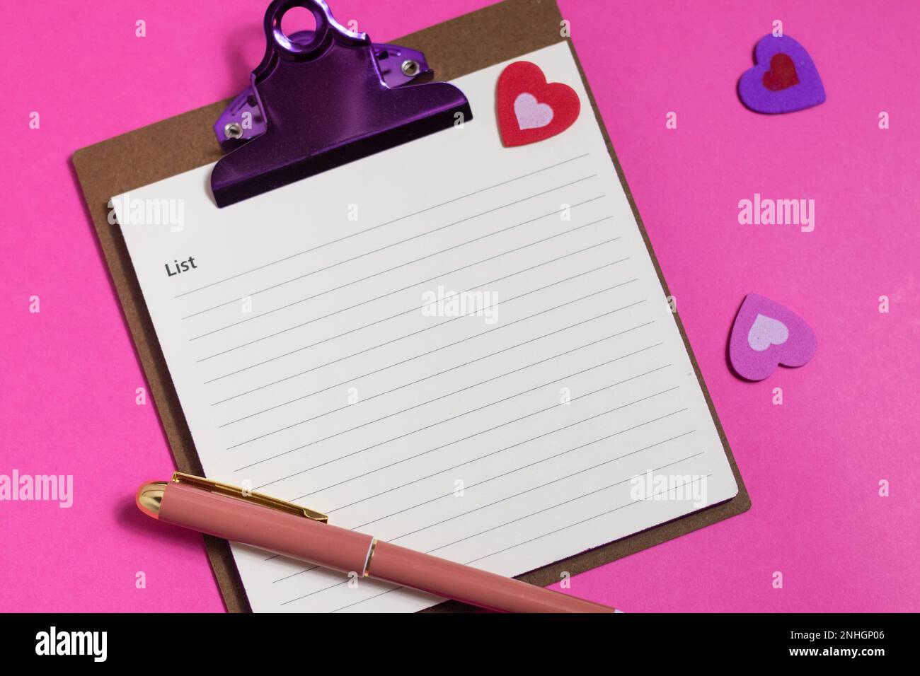 Women's pink office desk. Notepad, pen, stickers on a pink background ...