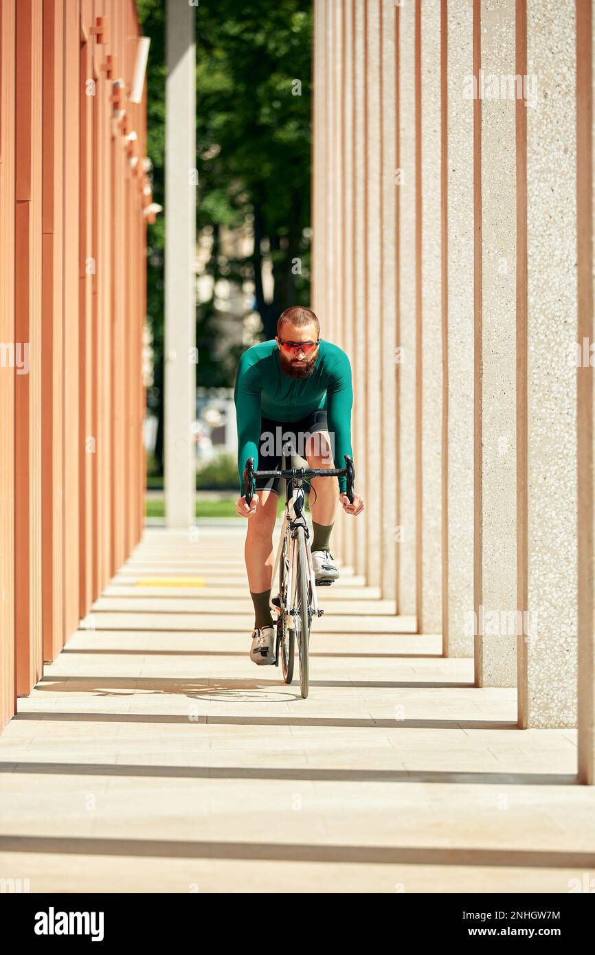 Handsome muscular cyclist standing with bike Stock Photo - Alamy