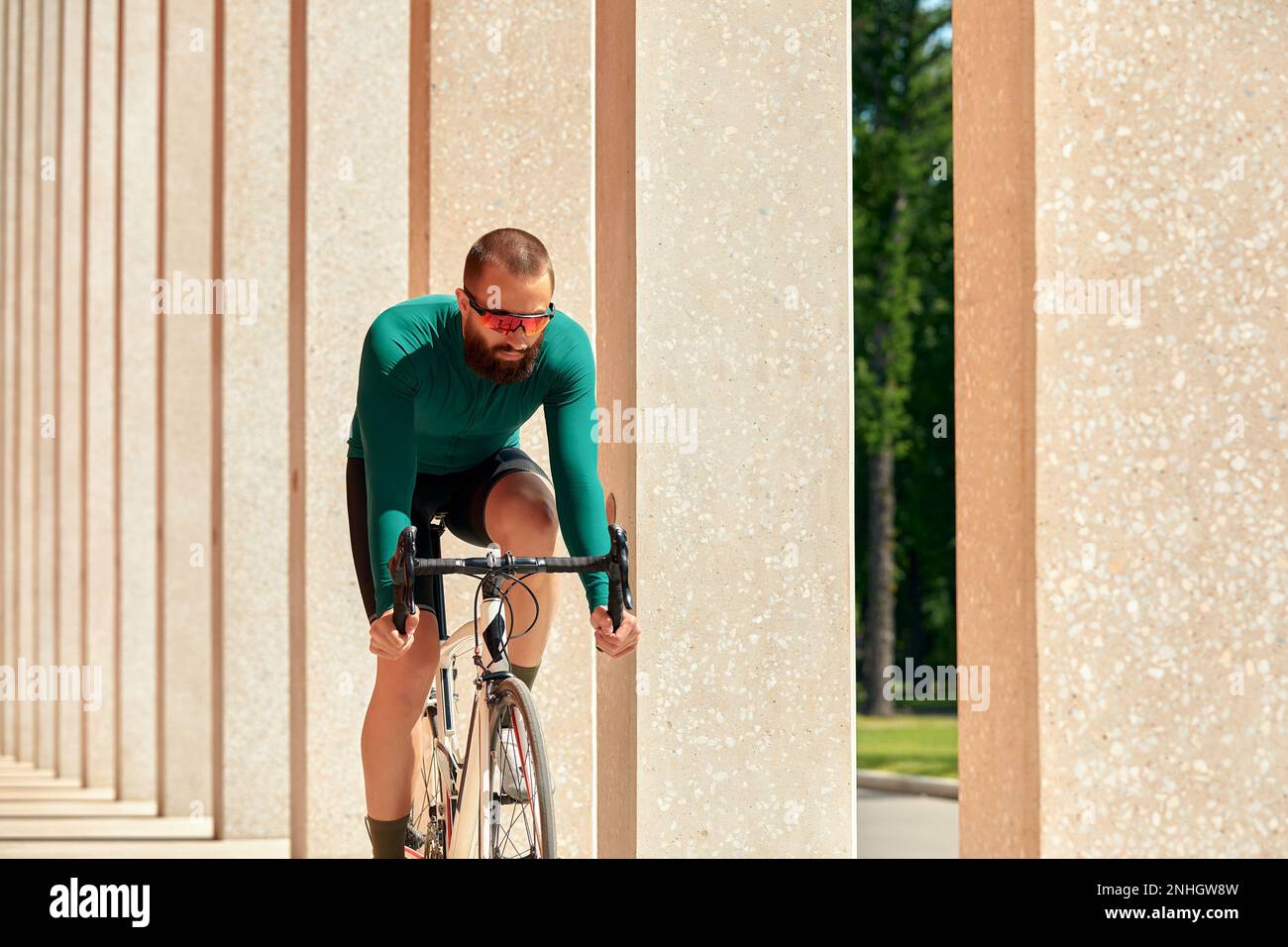 Handsome muscular cyclist standing with bike Stock Photo - Alamy