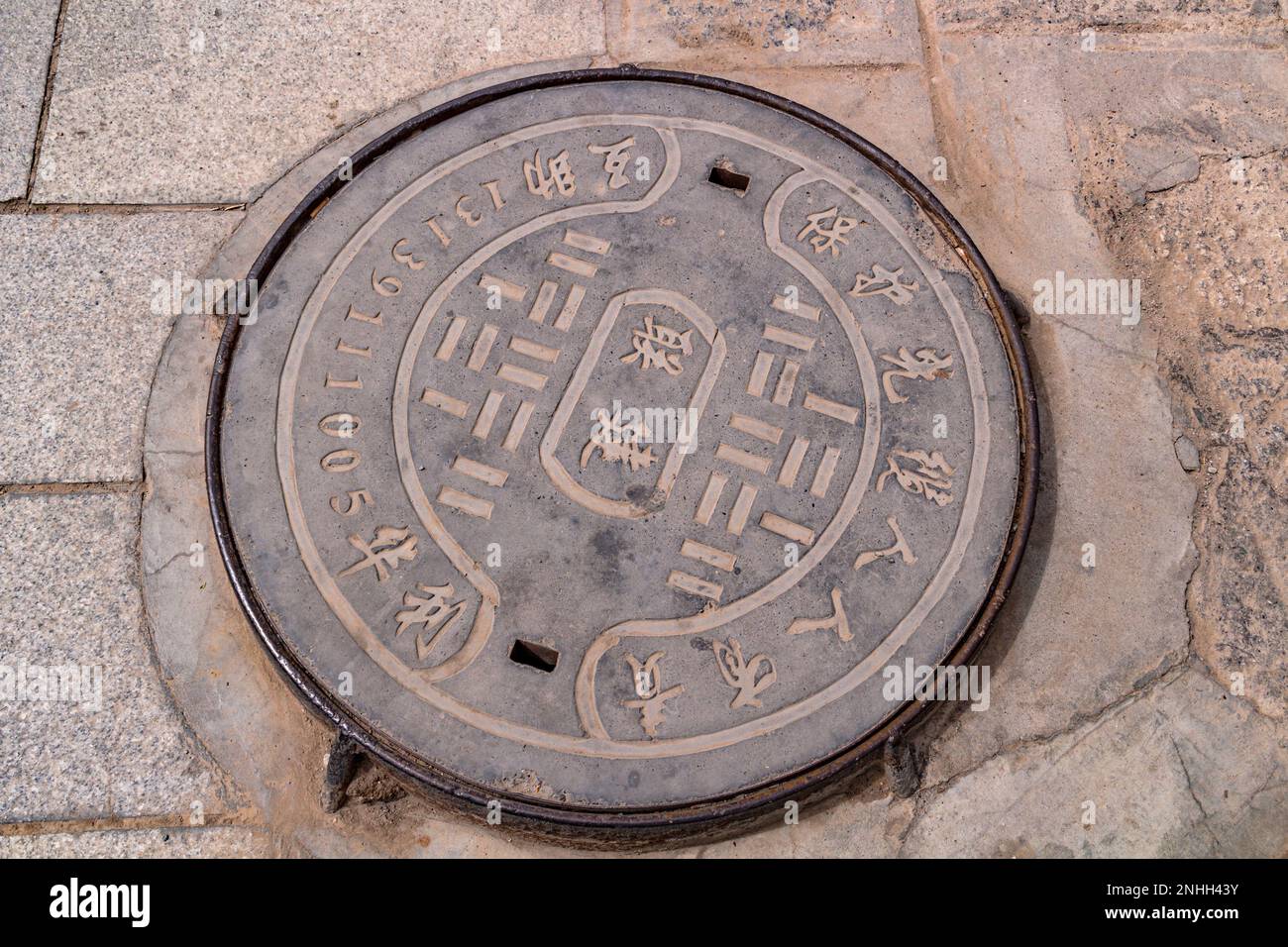 A manhole cover inscribed in Chinese in the courtyard of Kumbum Champa ...