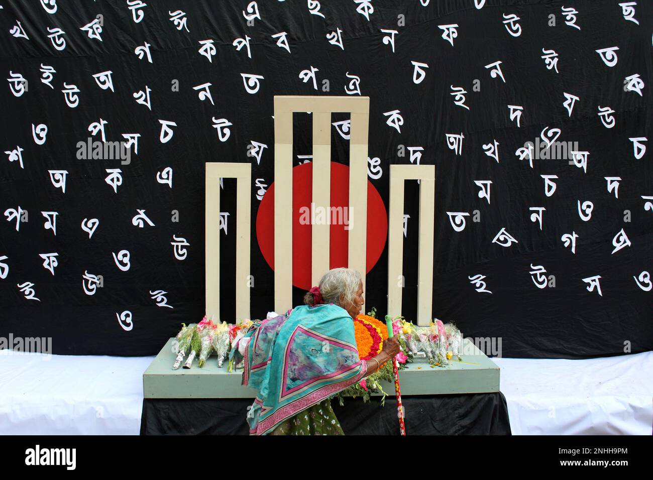 Joydebpur, Gazipur, Bangladesh. 21st Feb, 2023. An elderly woman pays ...