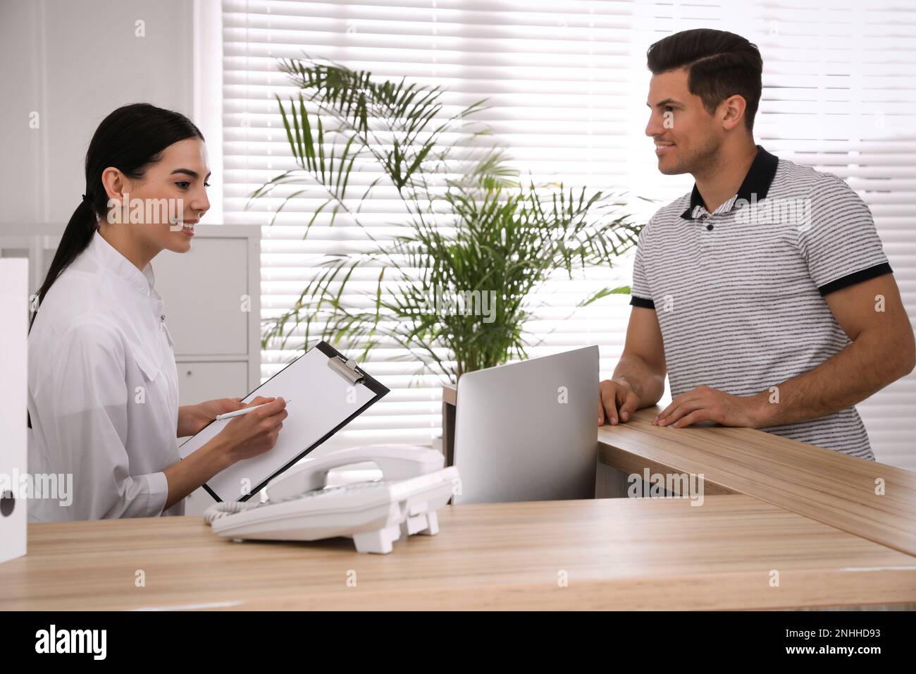 Nurse and patient at reception in hospital Stock Photo - Alamy
