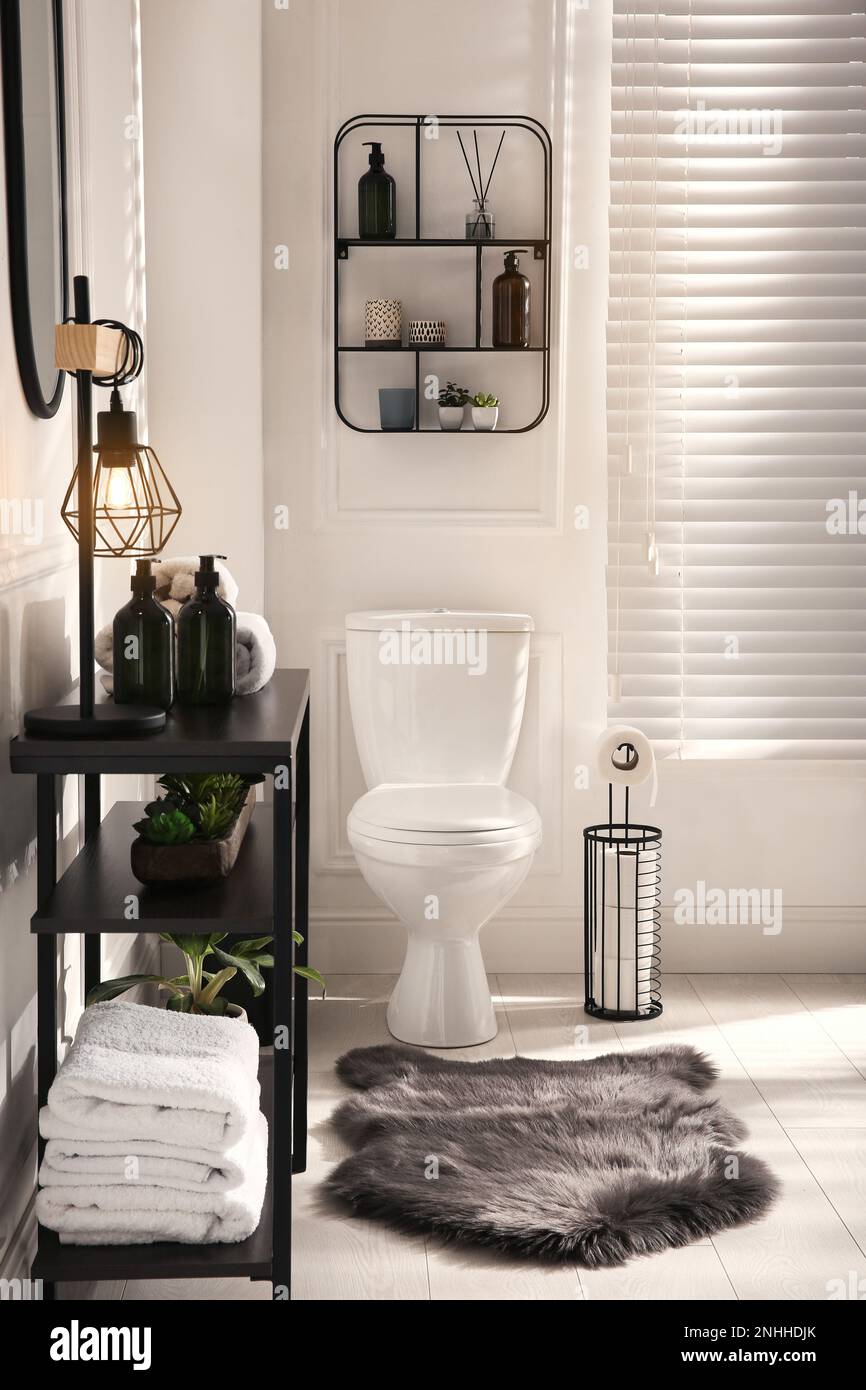 Modern toilet bowl in comfortable restroom. Interior design Stock Photo ...