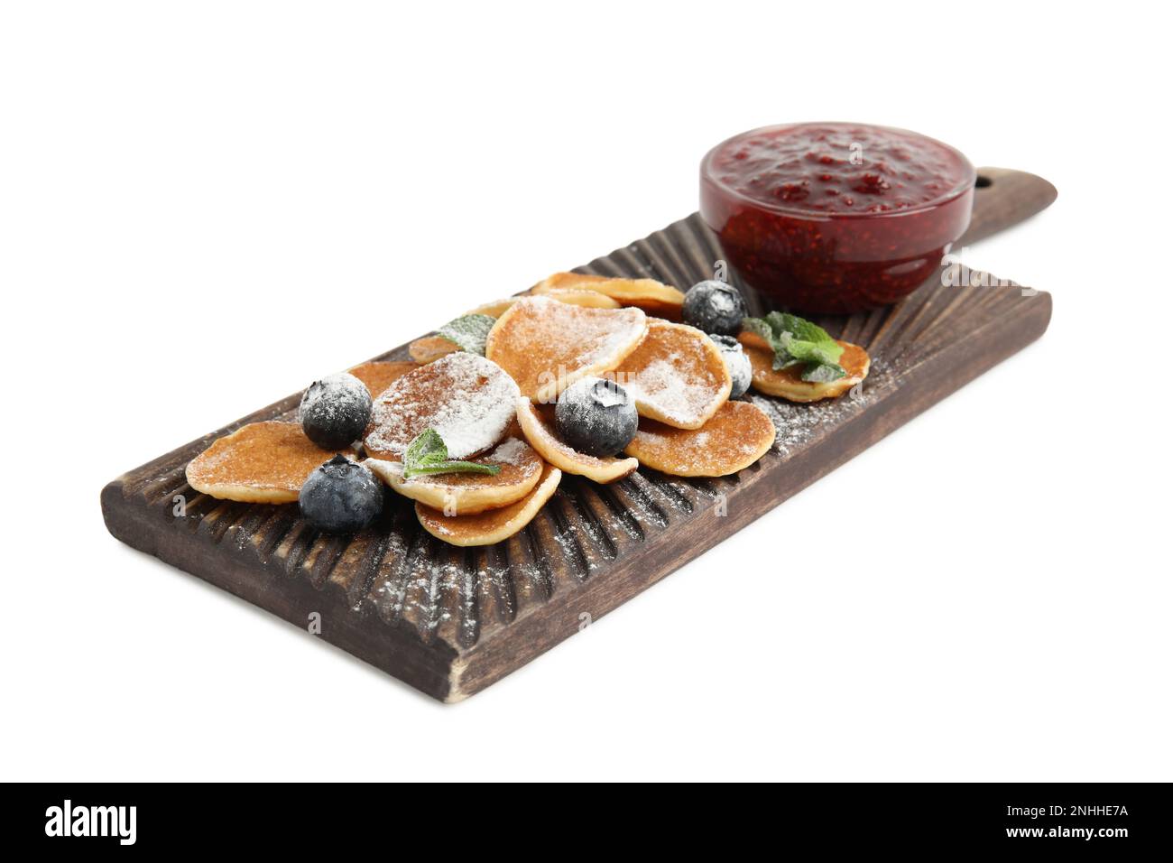 Wooden board with cereal pancakes, jam and blueberries on white ...