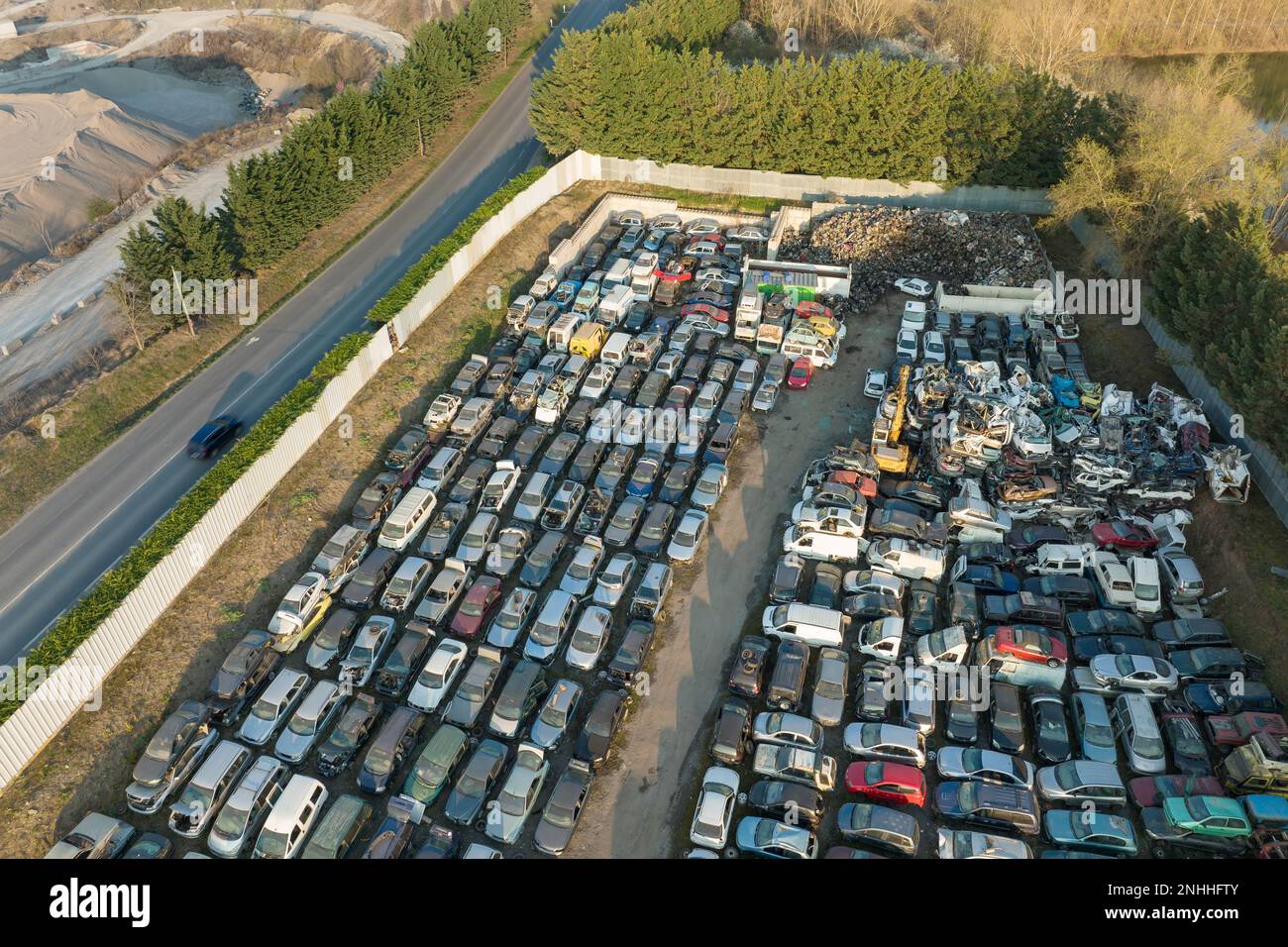 Aerial view of big parking lot of junkyard with rows of discarded ...
