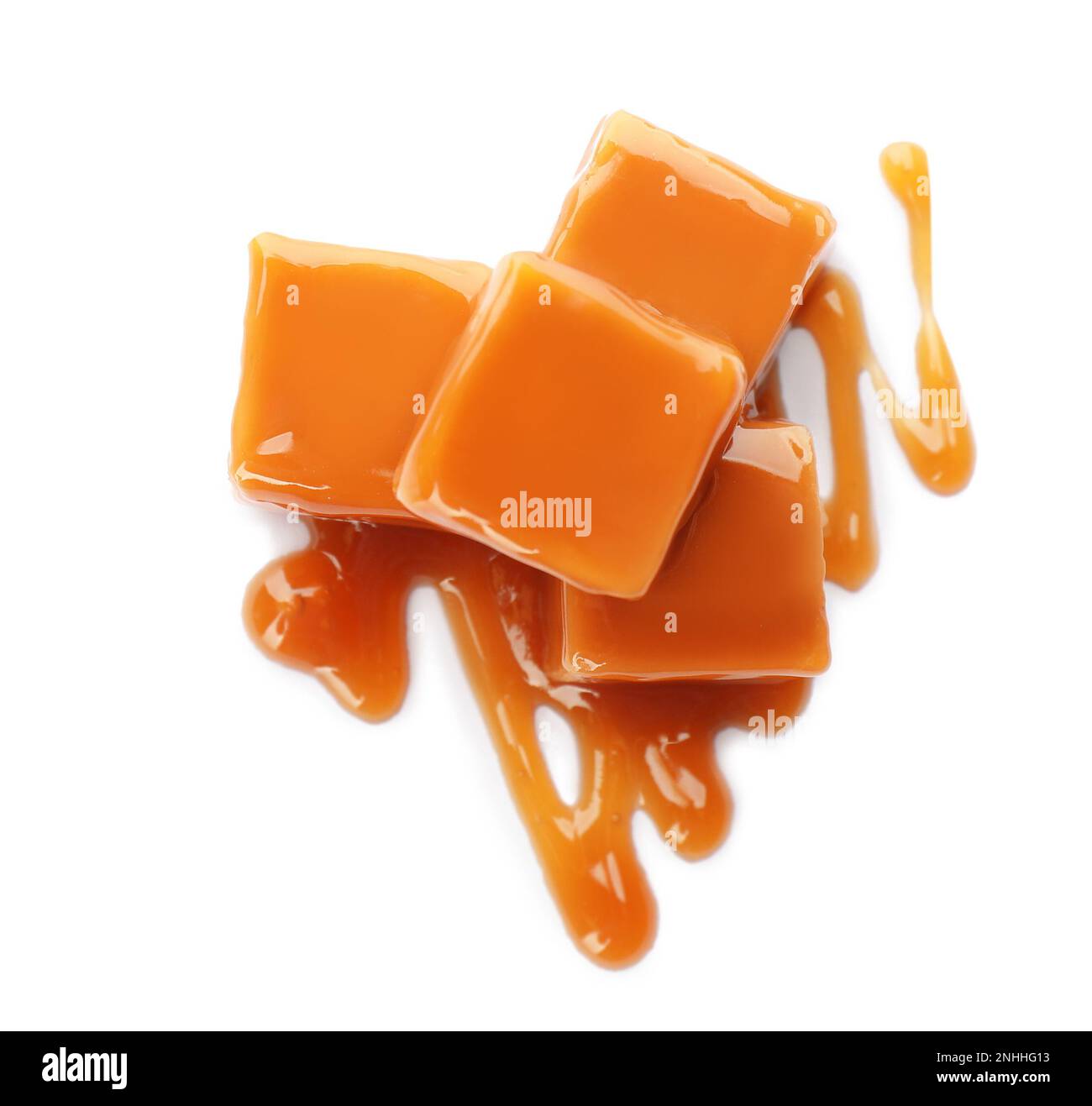 Heap of sweet caramel candies with topping isolated on white, top view ...
