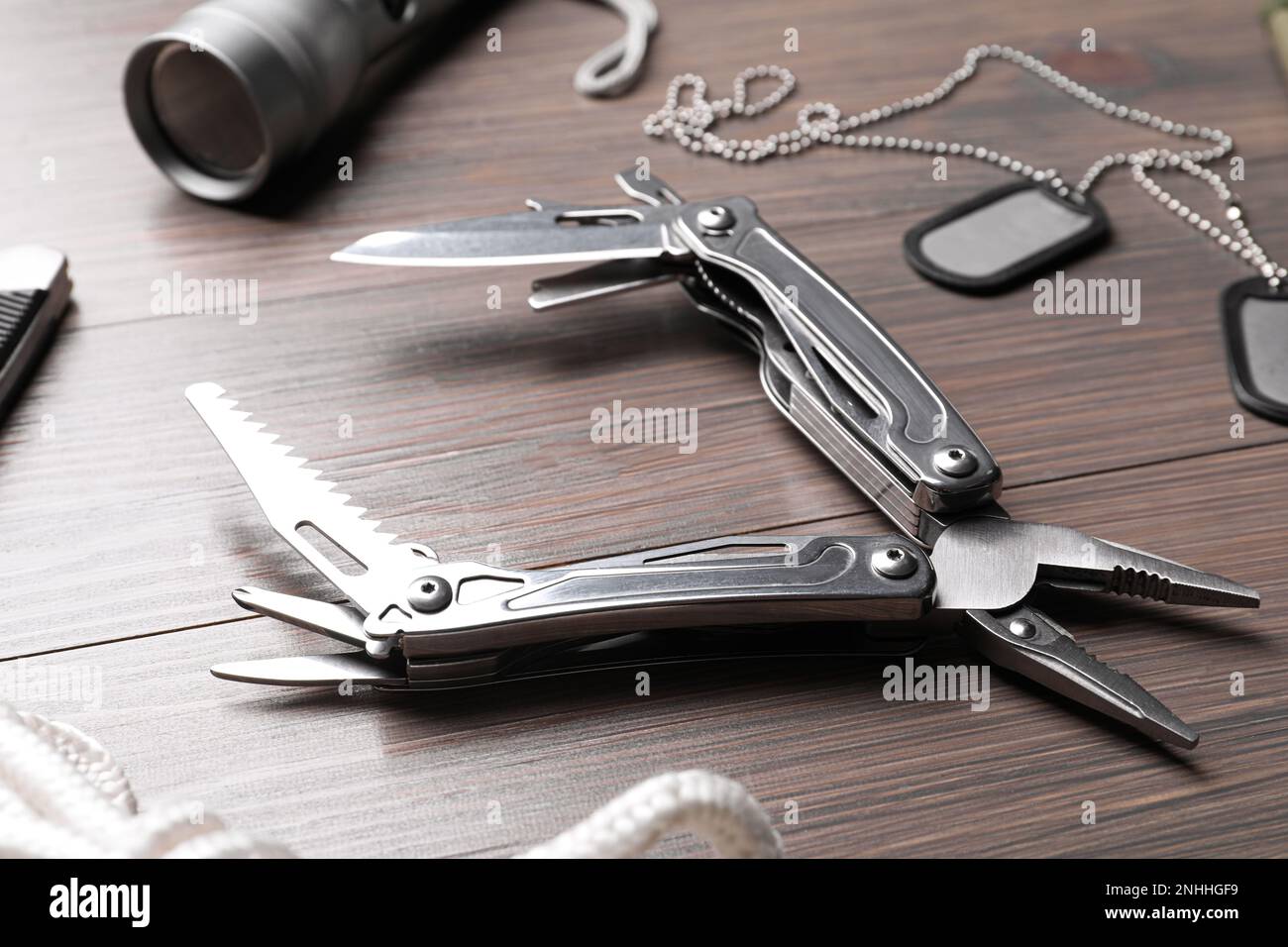 Modern compact portable multitool and accessories on wooden table Stock ...