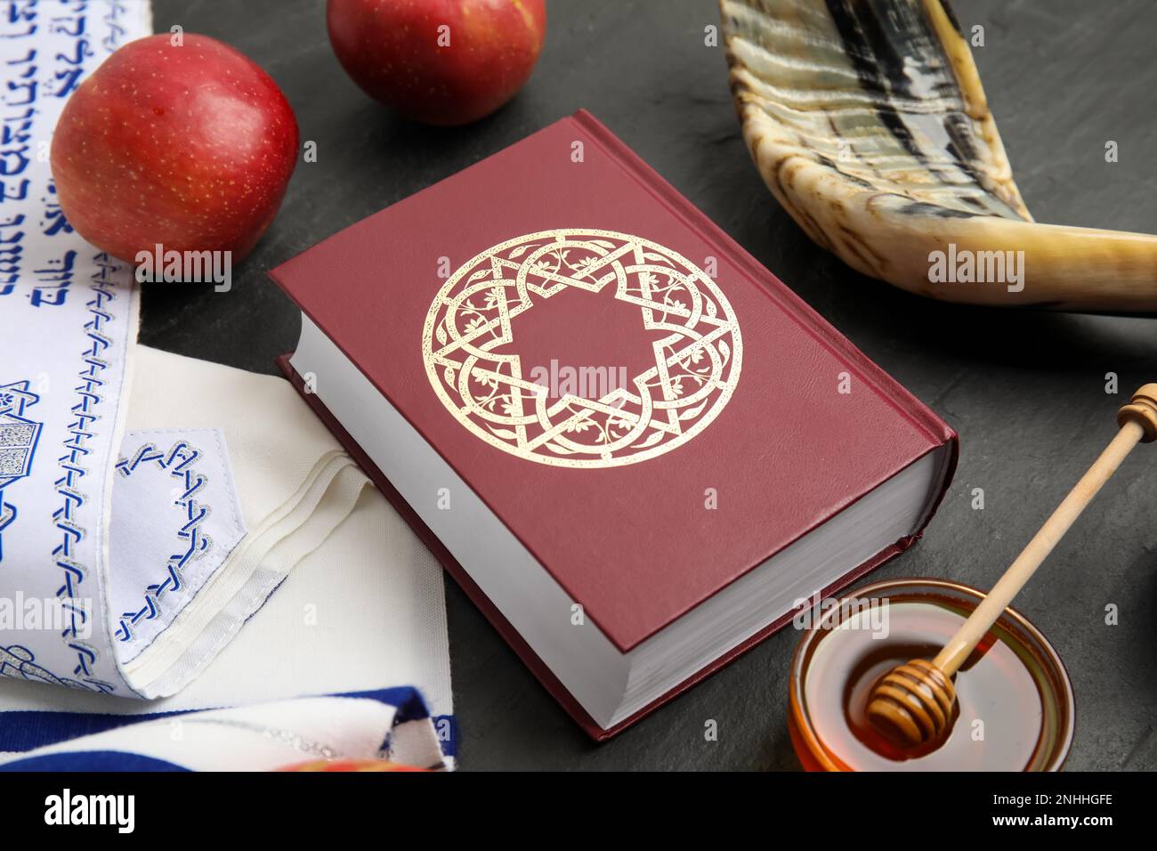 Traditional Rosh Hashanah holiday symbols on black table, closeup. Book ...
