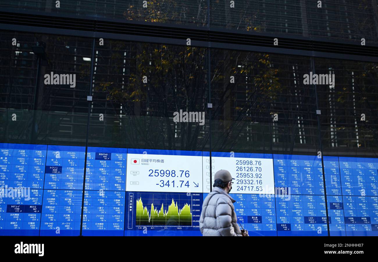 An electric board shows Nikkei stock average falling in Tokyo on Dec ...