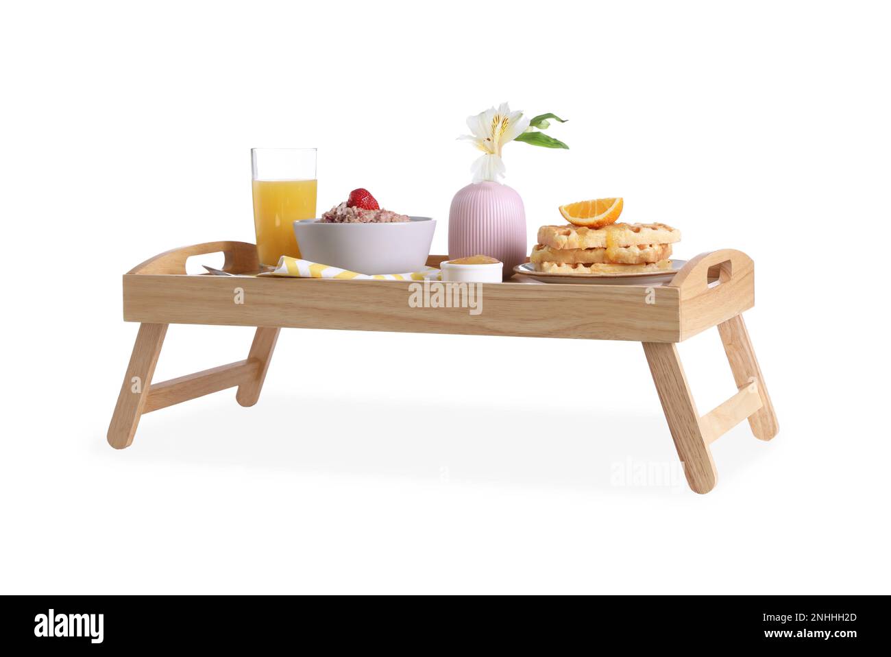 Wooden tray with delicious breakfast and beautiful flower on white ...