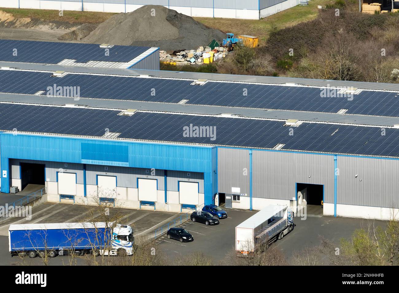 Aerial view of blue photovoltaic solar panels mounted on industrial ...