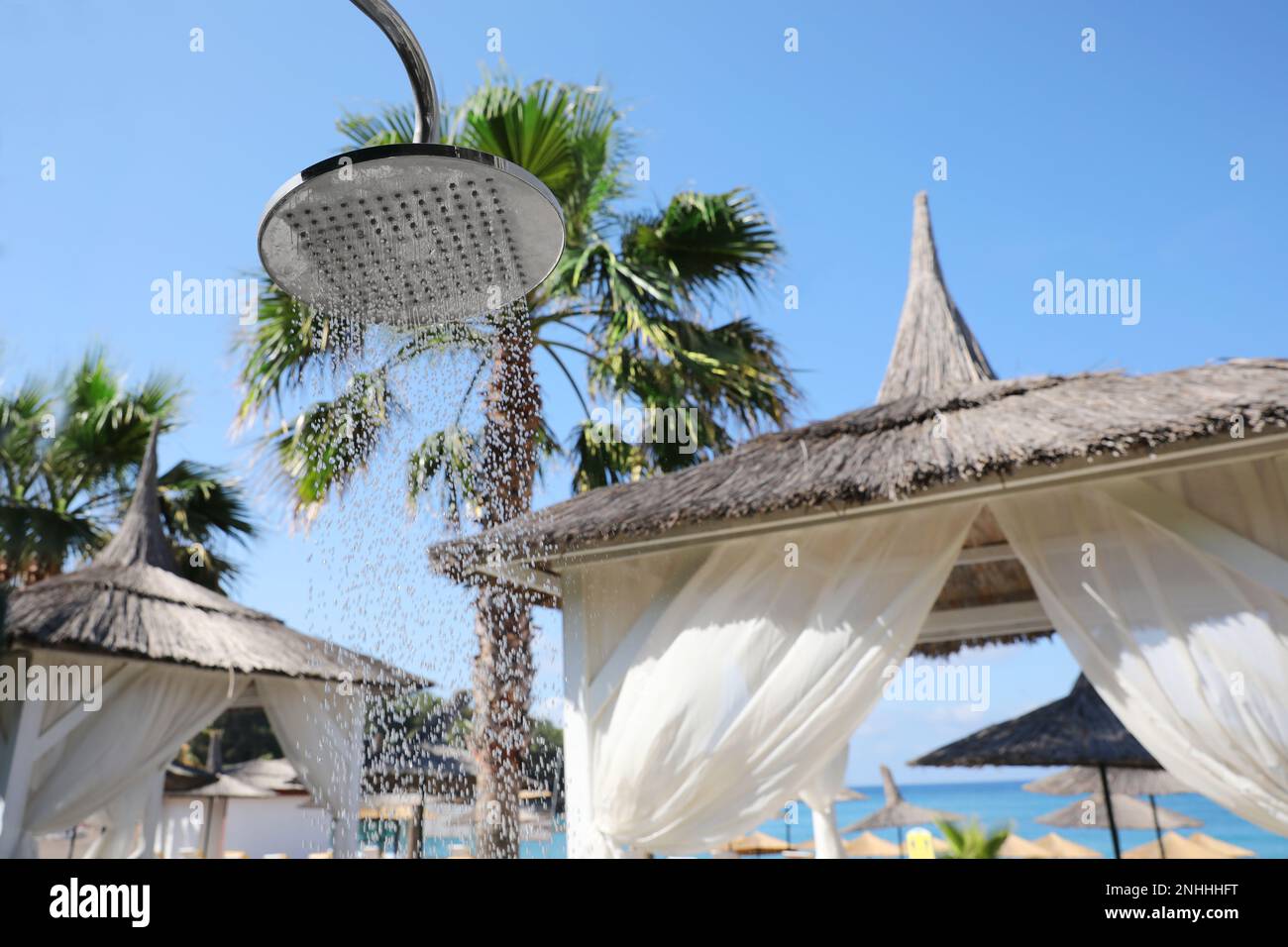 Outdoor shower with running water on beach at resort Stock Photo - Alamy