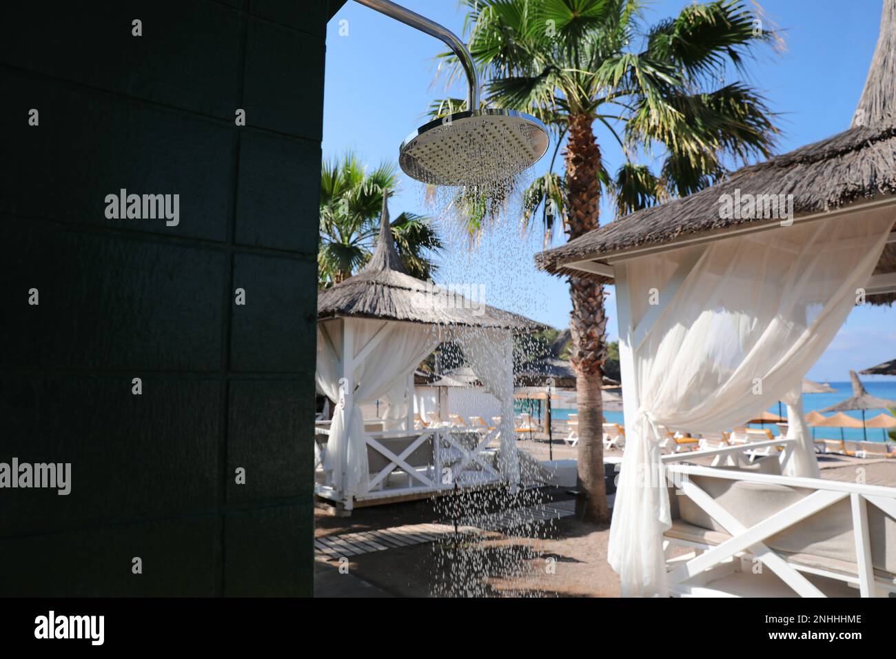 Outdoor shower with running water on beach at resort Stock Photo - Alamy
