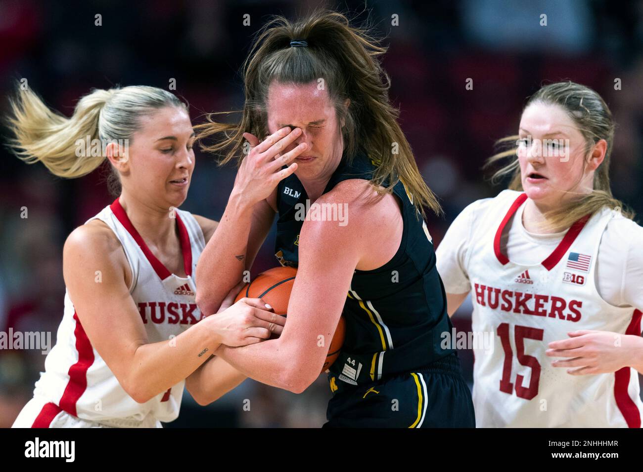 Michigan's Leigha Brown, center, reacts after being hit in the eye as ...