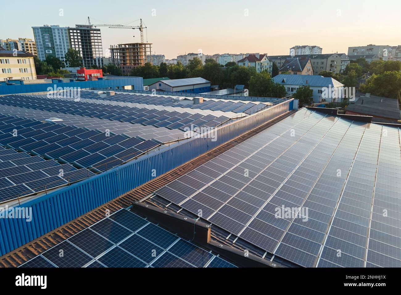 Aerial view of blue photovoltaic solar panels mounted on industrial ...