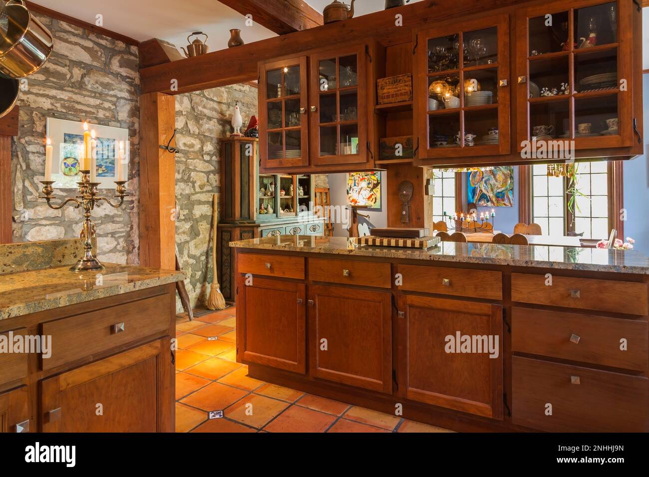 Stained wooden shaker style cabinets and nuanced granite countertops in ...