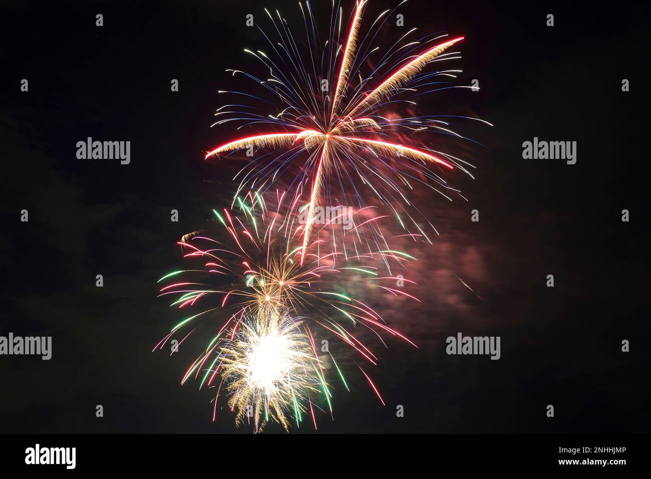 Aerial view of bright fireworks exploding with colorful lights against ...