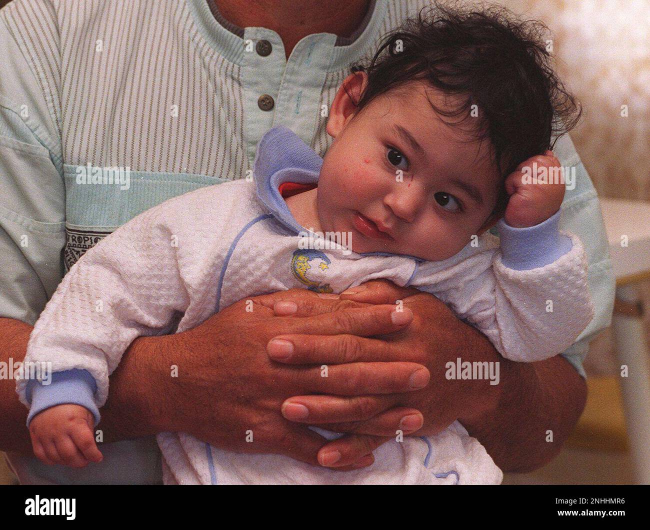 BABYBEATING2/C/08APR97/MN/MACOR Ignacio Bermudez craddles his son, one ...