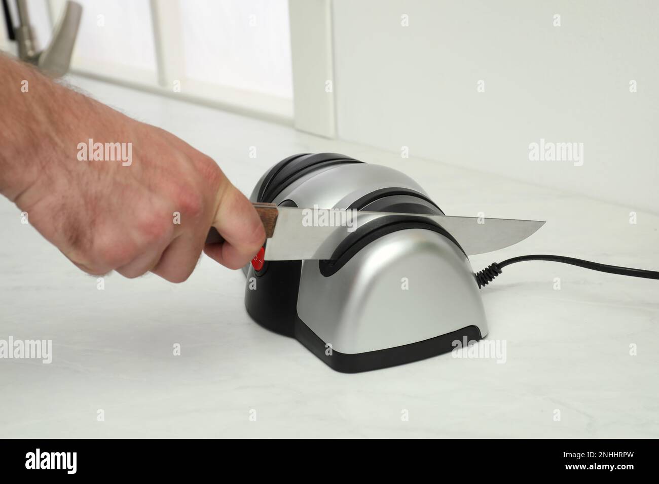 Man sharpening knife electrical hi-res stock photography and images - Alamy