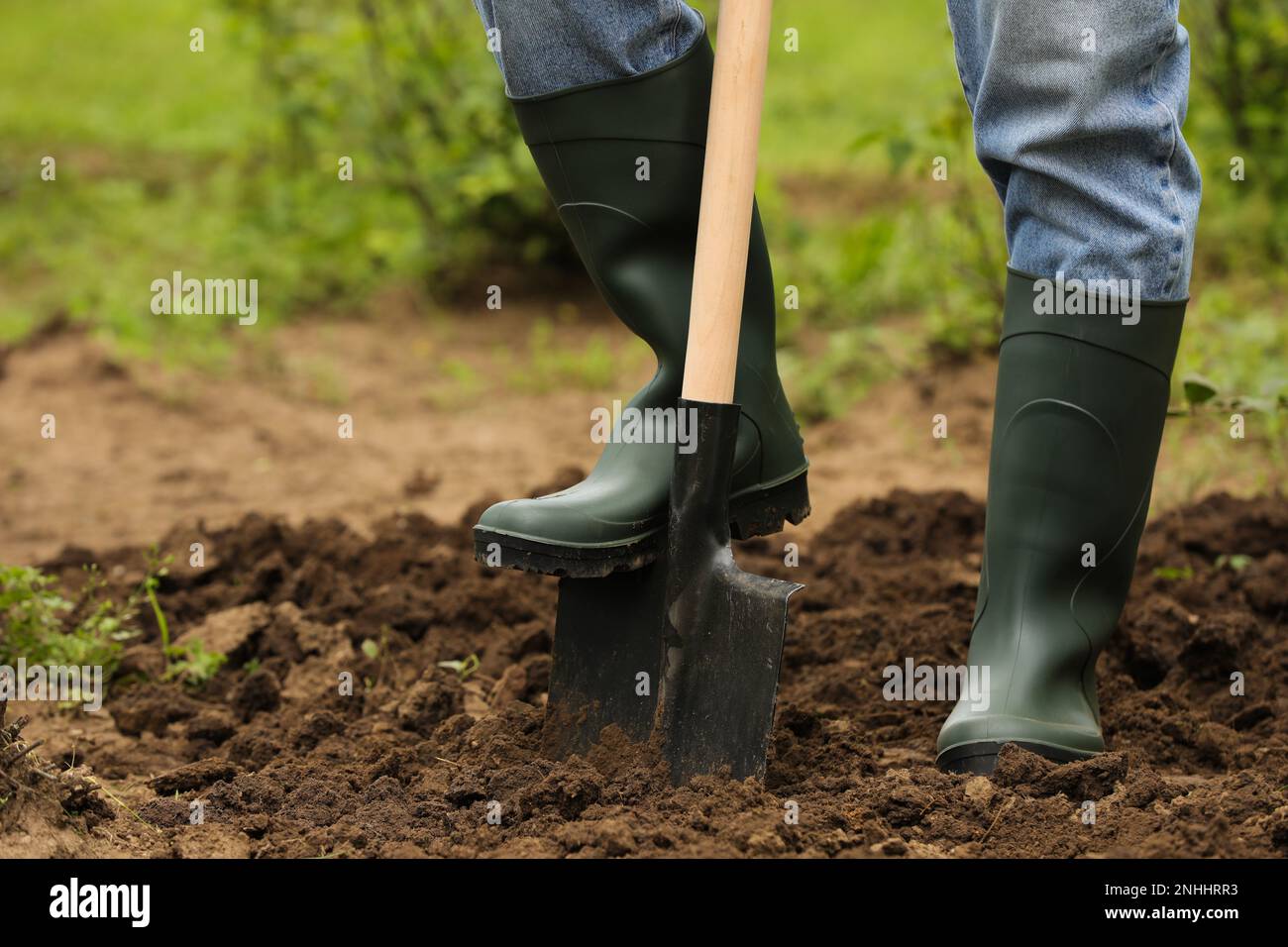 Worker digging soil with shovel outdoors, closeup. Gardening tool Stock ...