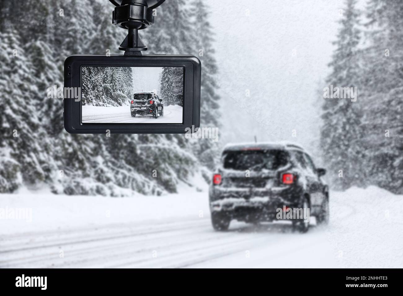 Modern dashboard camera mounted in car, view of road during driving ...