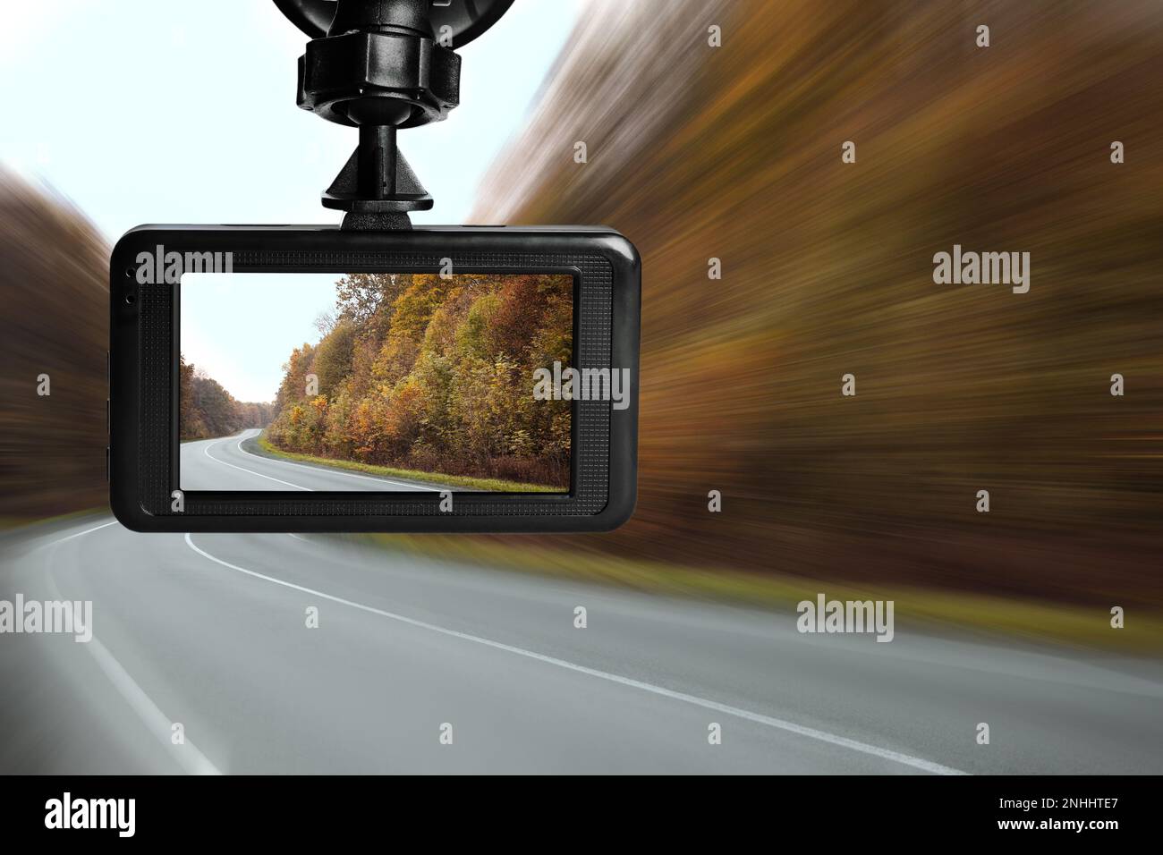 Modern dashboard camera mounted in car, view of road during driving ...