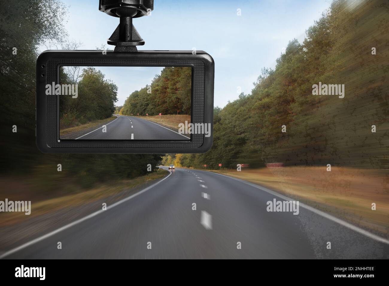Modern dashboard camera mounted in car, view of road during driving ...
