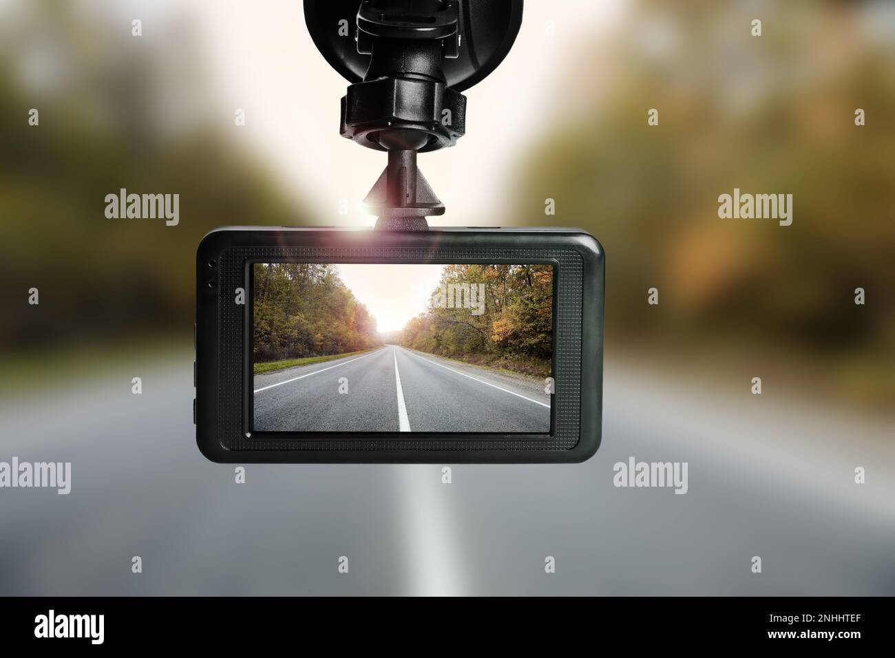 Modern dashboard camera mounted in car, view of road during driving ...