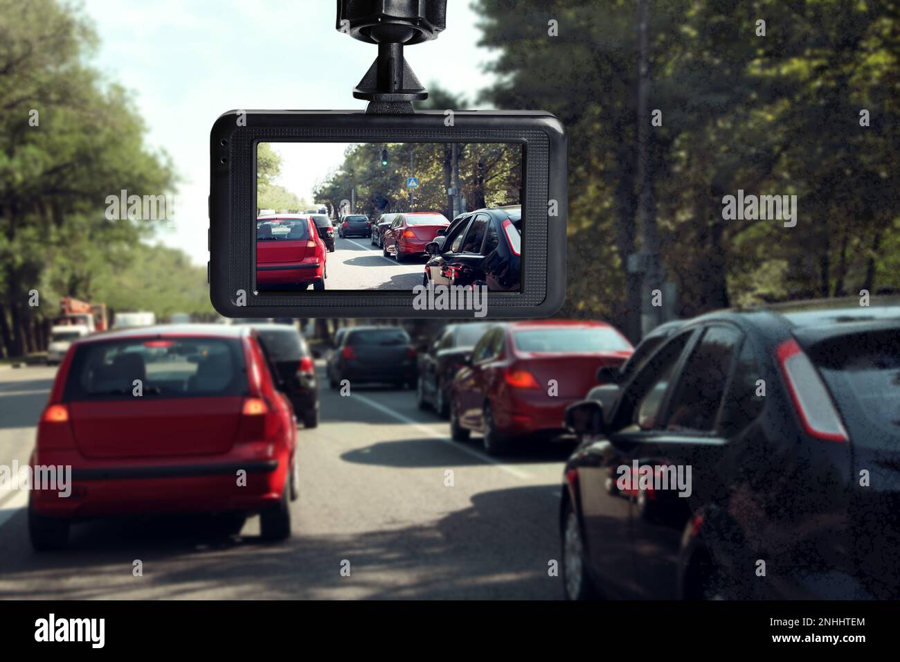 Modern dashboard camera mounted in car, view of road during driving ...