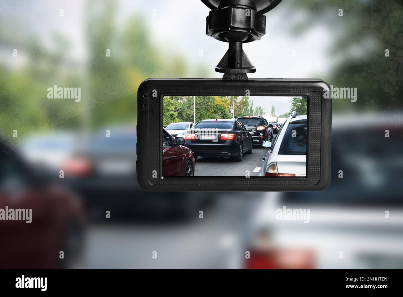 Modern dashboard camera mounted in car, view of road during driving ...