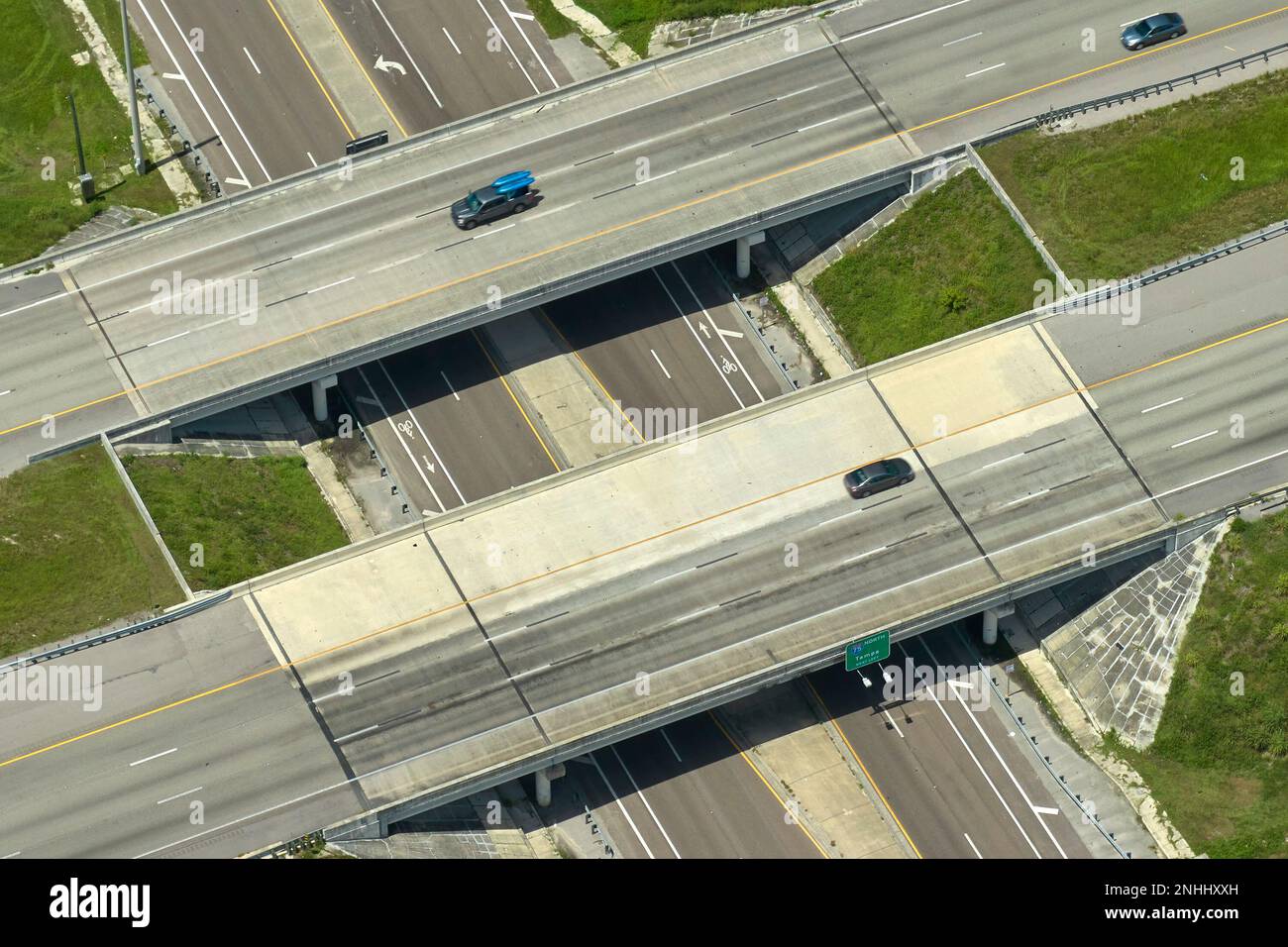 Aerial view of freeway overpass junction with fast moving traffic cars ...