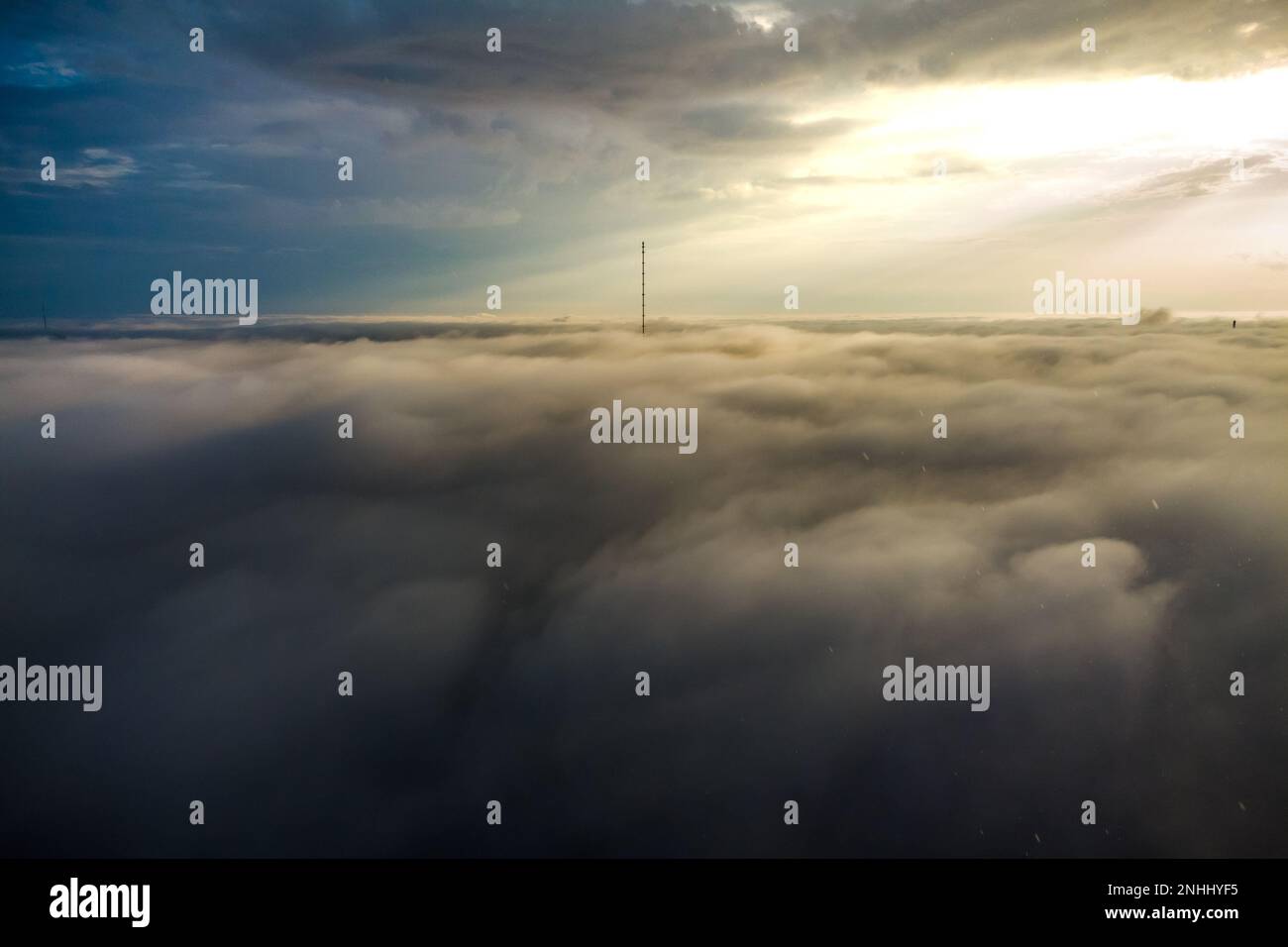 Flying over low clouds during fog cloud scape Stock Photo - Alamy