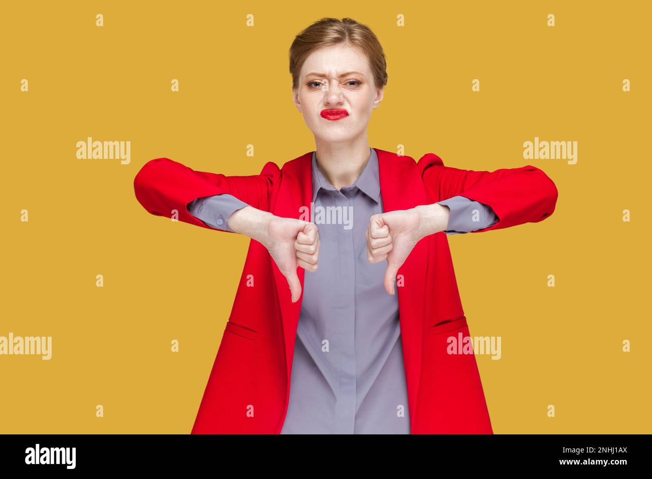 Portrait of sad upset young adult woman with red lips standing and ...