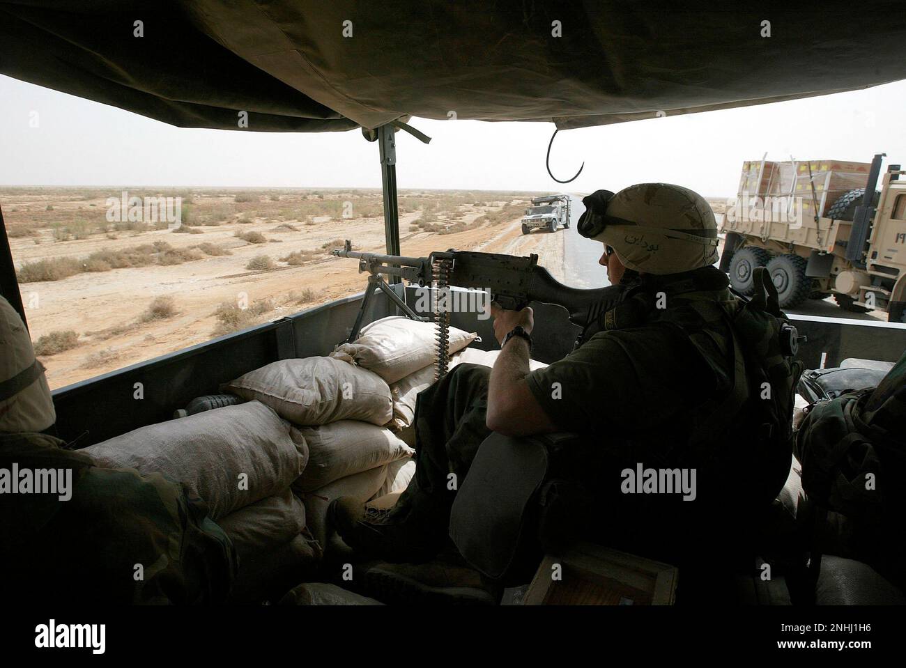 IRAQ1-C-31MAR03-MT-MAC Sgt. Beaudine covers the rear of the convoy with ...