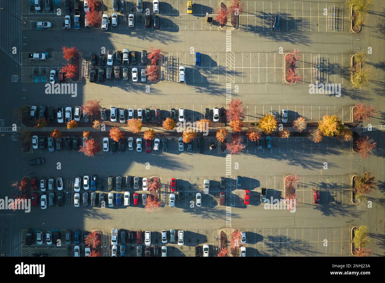 Aerial view of large parking lot with many parked colorful cars ...