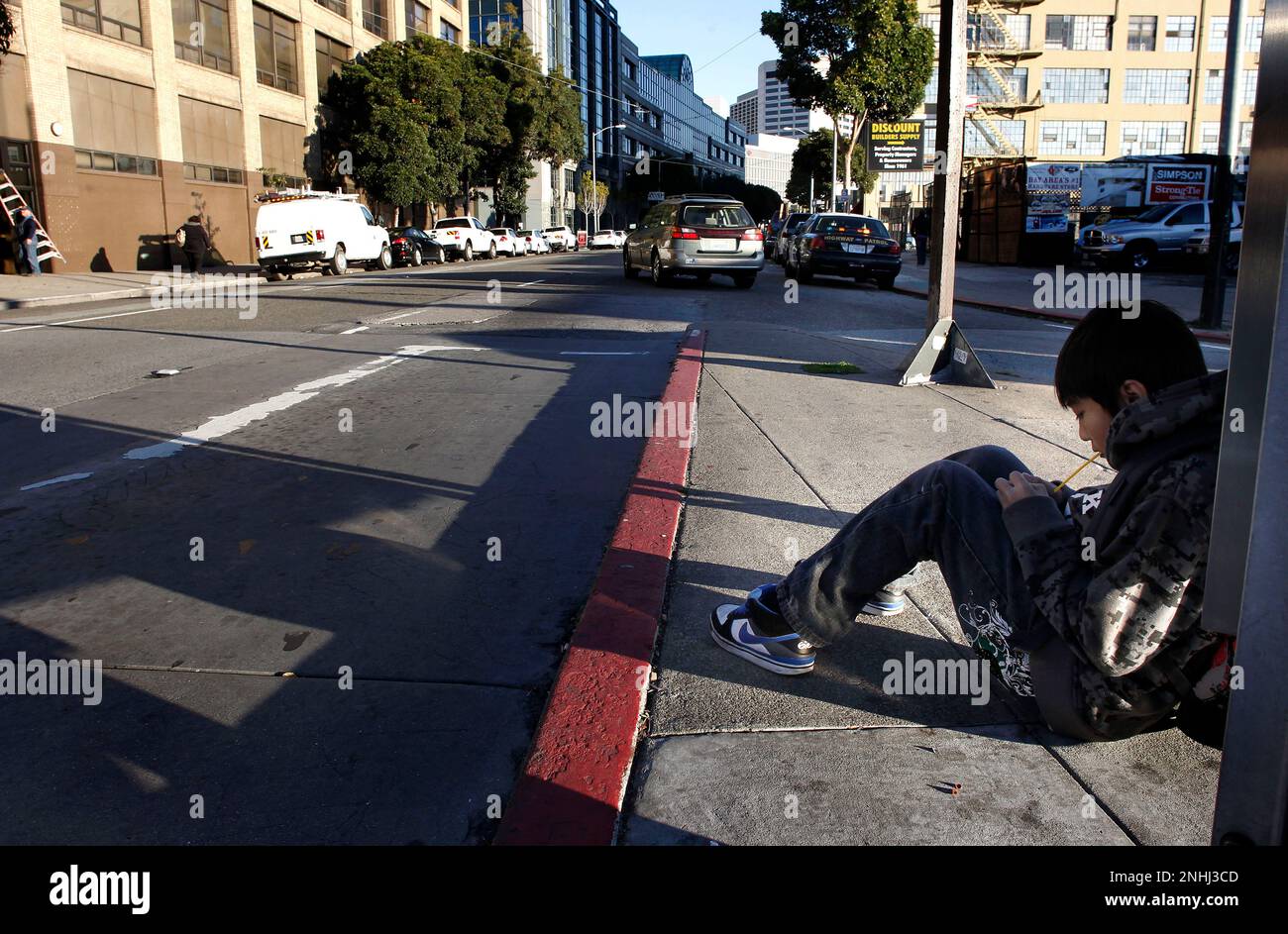 10-year-old Rudy waits for the MUNI bus to school with his family on ...