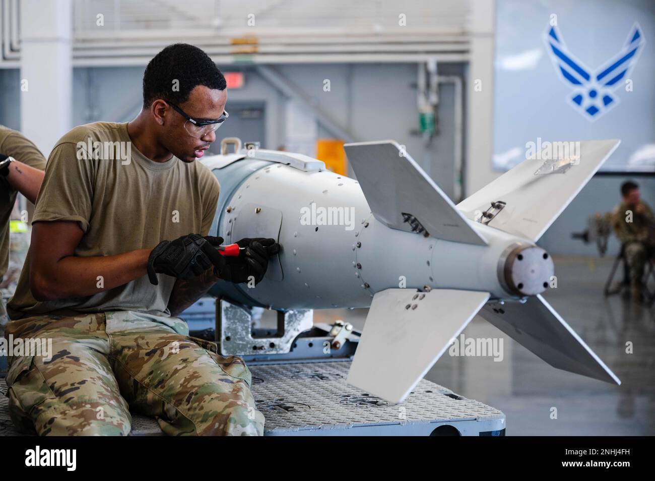 Senior Airman David Gibbs II, 2nd Munitions Squadron munitions inspector, installs a tail kit on ...