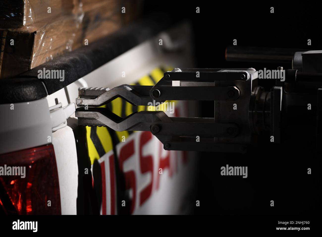 The claw of an Andros F6 robot attempts to pull a handle of a ...