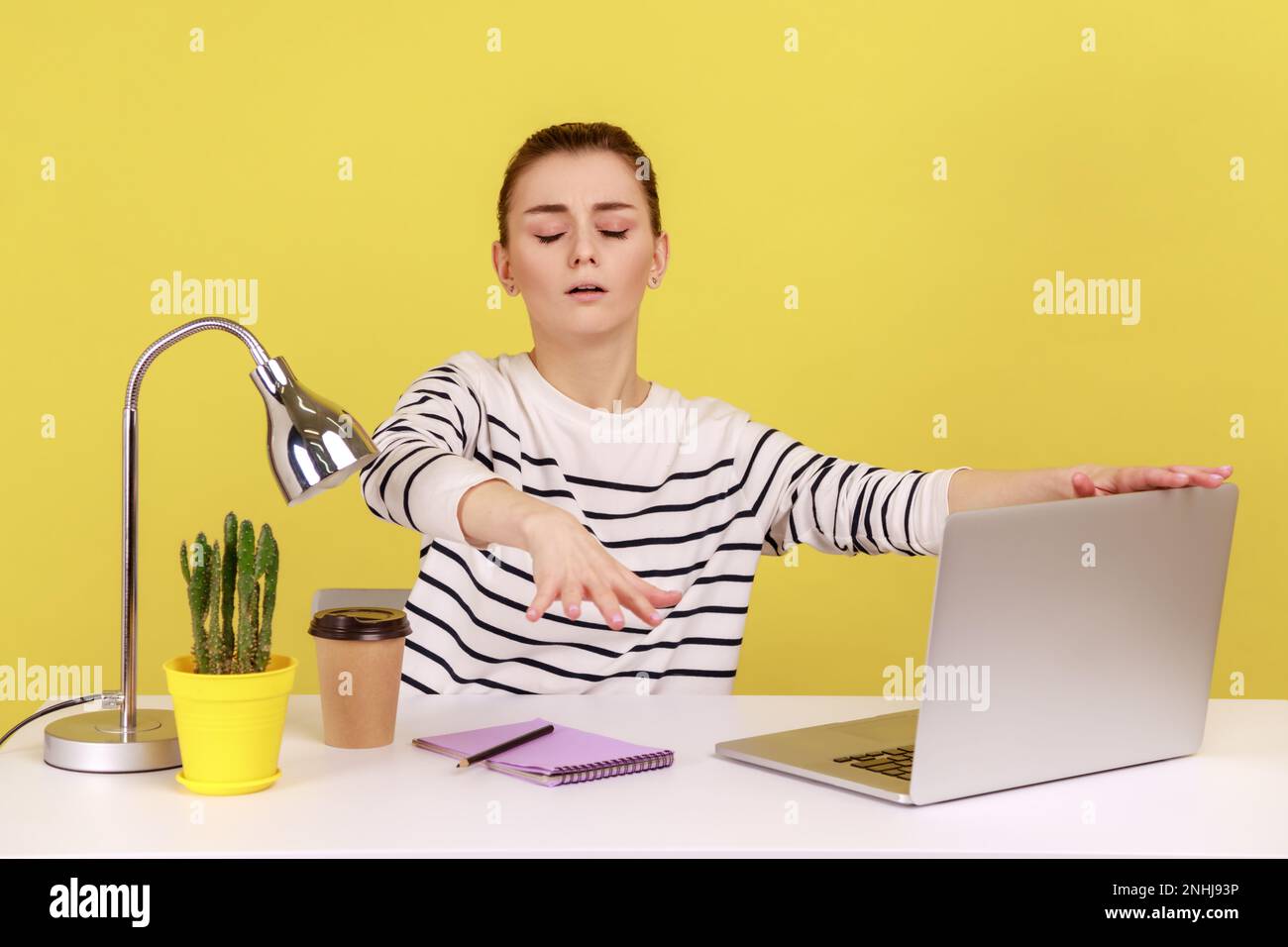 Disoriented blind woman employee sitting at workplace with laptop and ...