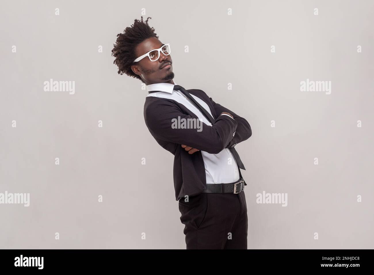 Side view portrait of funny man in glasses standing with crossed arms ...