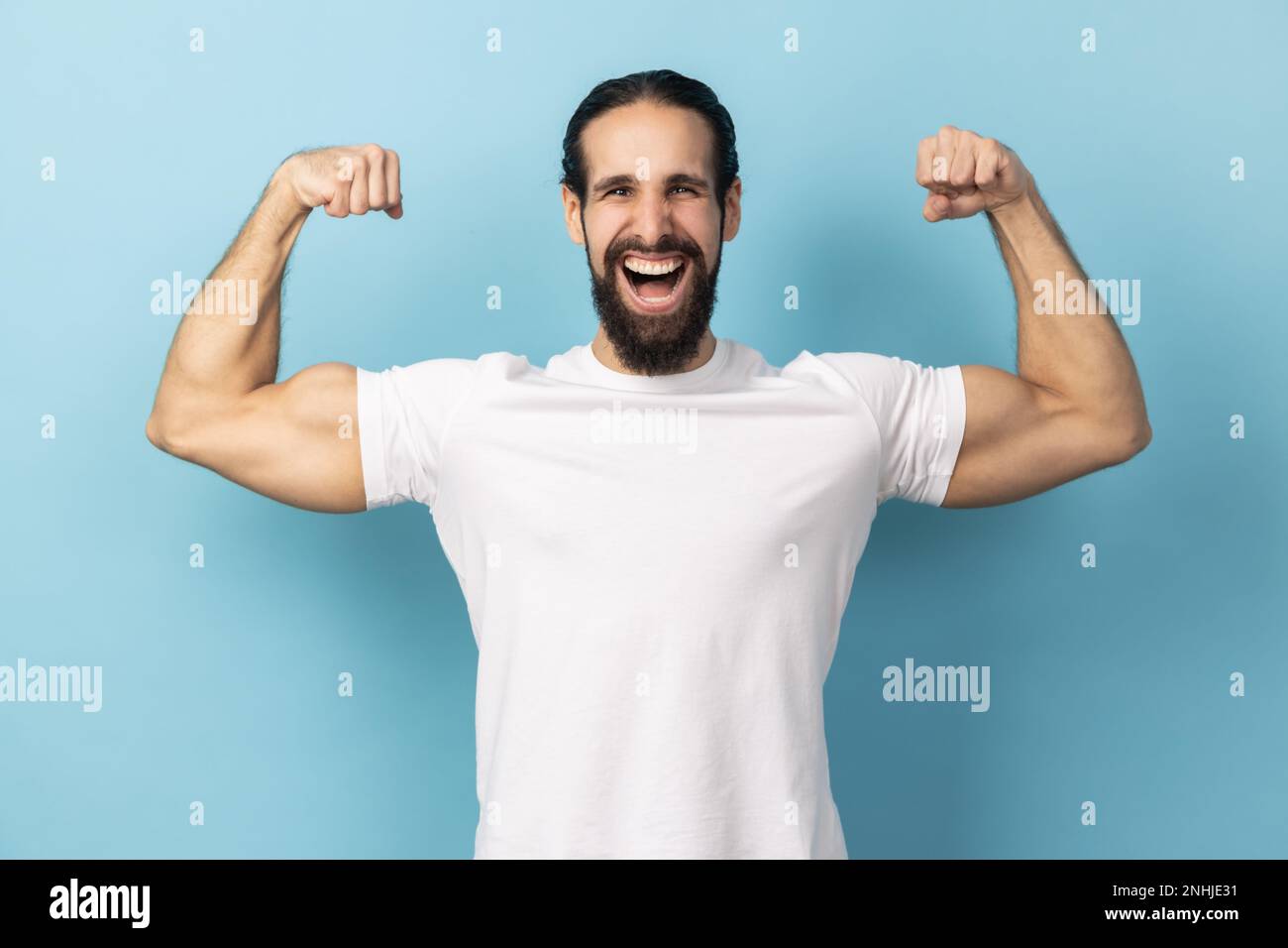 Portrait of independent self confident man bodybuilder wearing white T ...