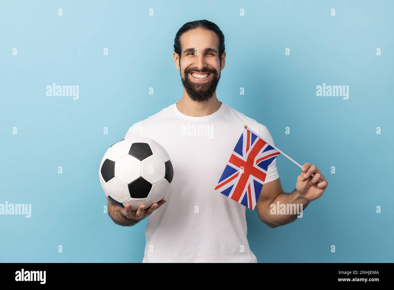 Portrait of satisfied man with beard wearing white T-shirt holding ...